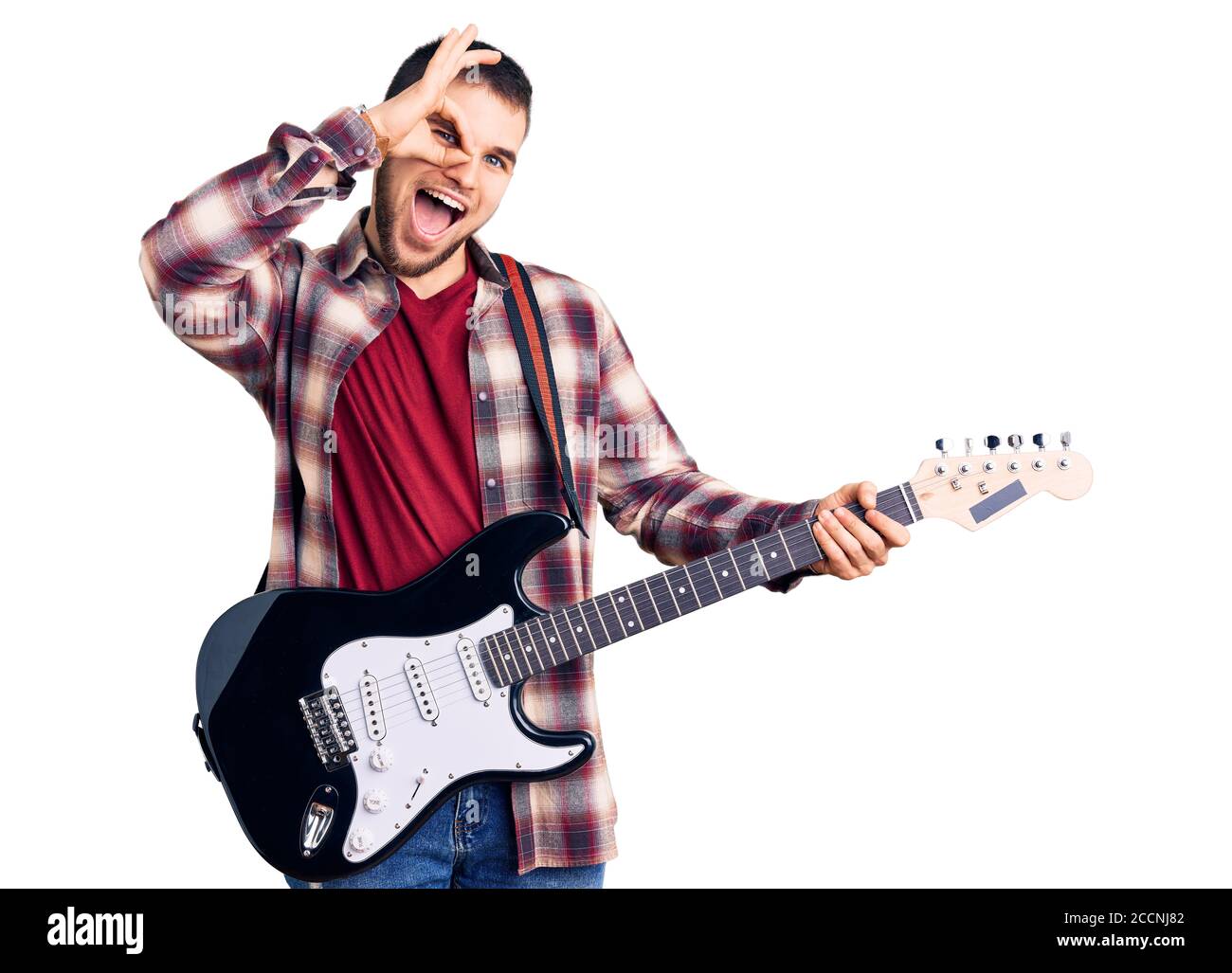 Young handsome man playing electric guitar smiling happy doing ok sign ...