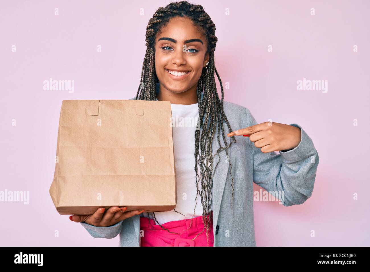 Young african american business woman with braids holding take away ...