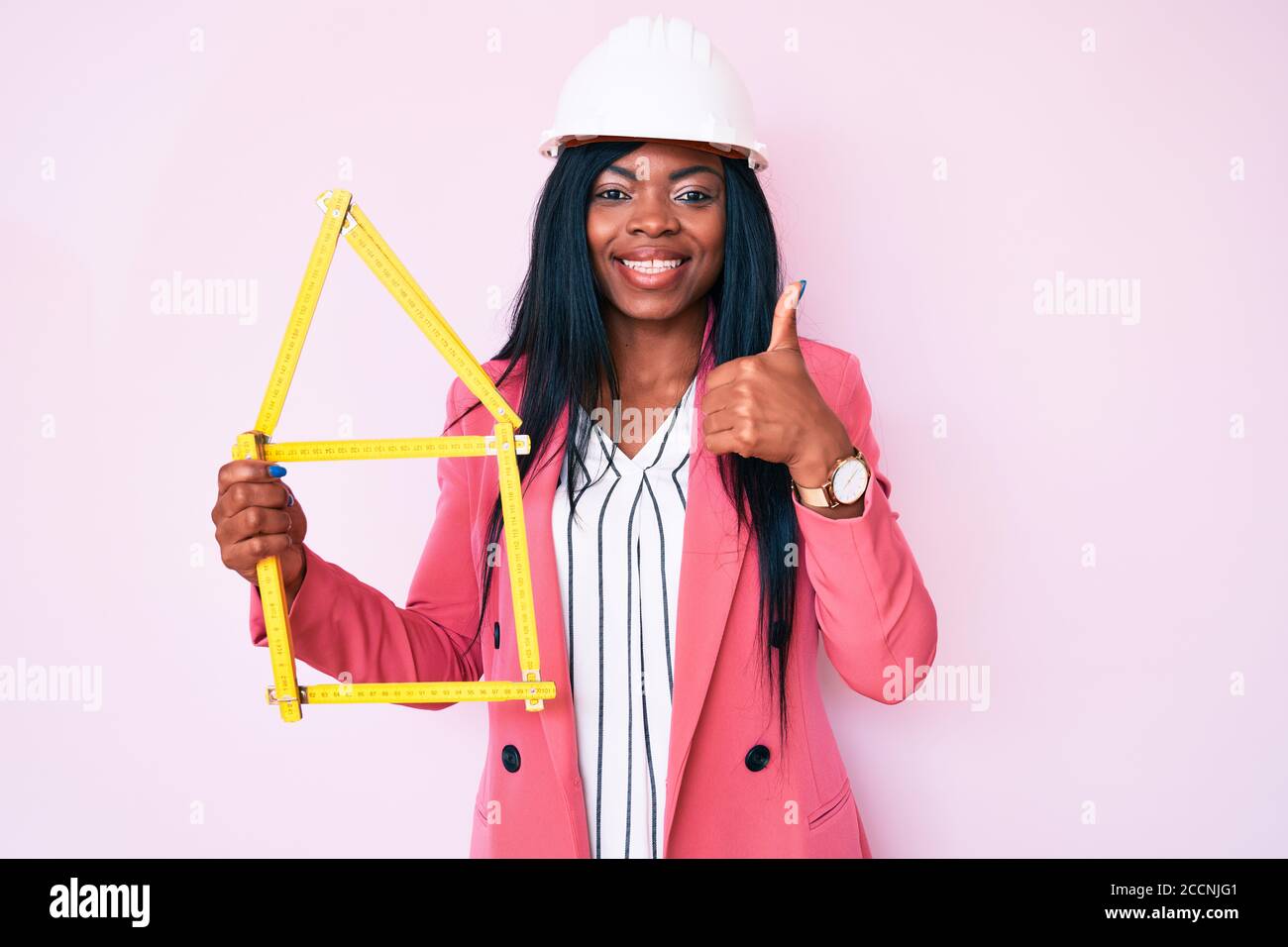 Young african american woman wearing bike helmet and holding water ...