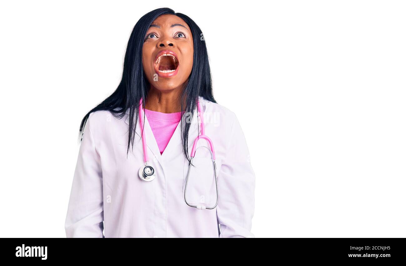 Young african american woman wearing doctor stethoscope angry and mad ...