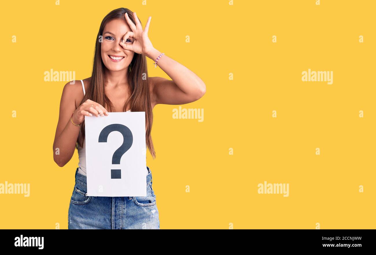 Young beautiful hispanic woman holding question mark smiling happy ...