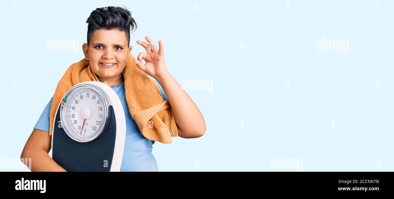 Little boy kid holding weight machine to balance weight loss doing ok ...