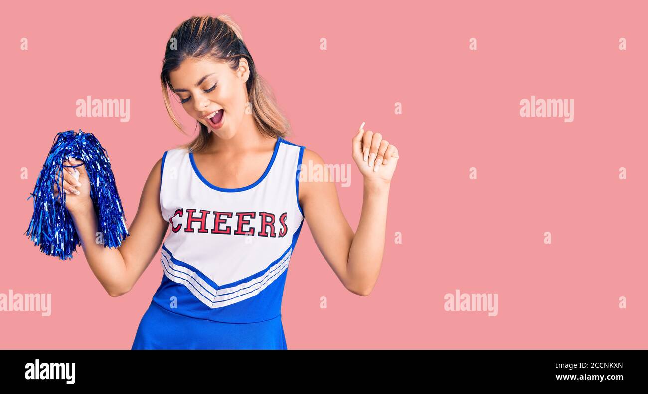 Young Beautiful Woman Wearing Cheerleader Uniform Pointing Down With