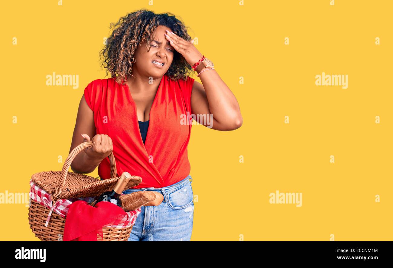 Young african american plus size woman holding picnic wicker basket ...