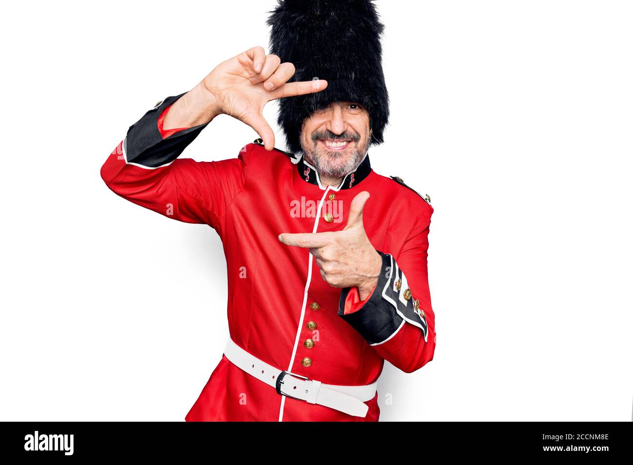 Middle age handsome wales guard man wearing traditional uniform over ...