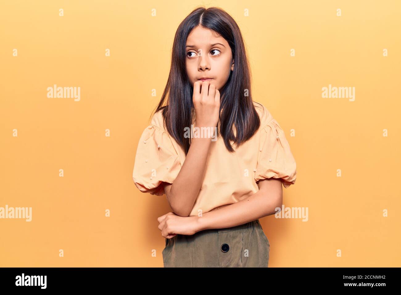 Beautiful child girl wearing casual clothes serious face thinking about ...
