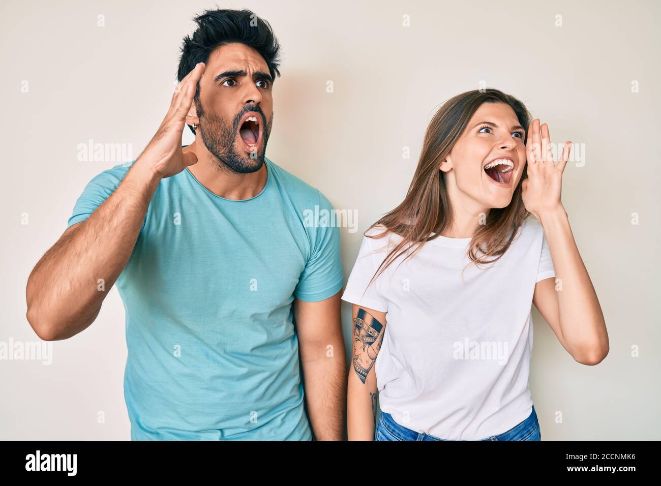 Beautiful young couple of boyfriend and girlfriend together shouting ...