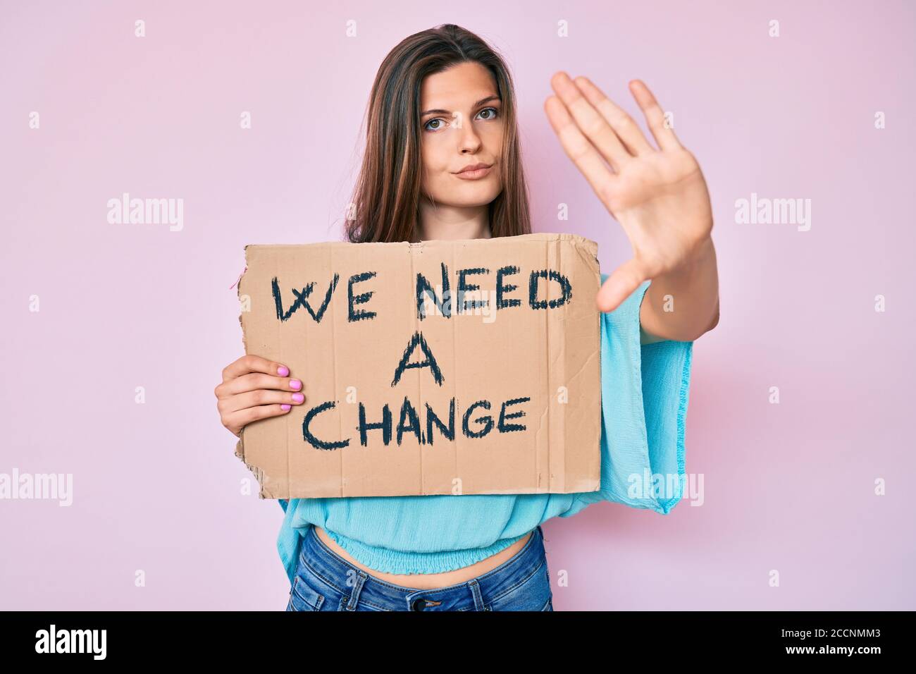 Beautiful caucasian woman holding we need a change banner with open ...