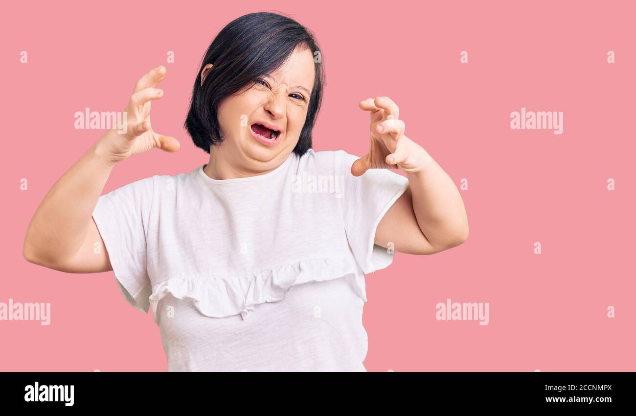Brunette woman with down syndrome wearing casual white tshirt shouting ...
