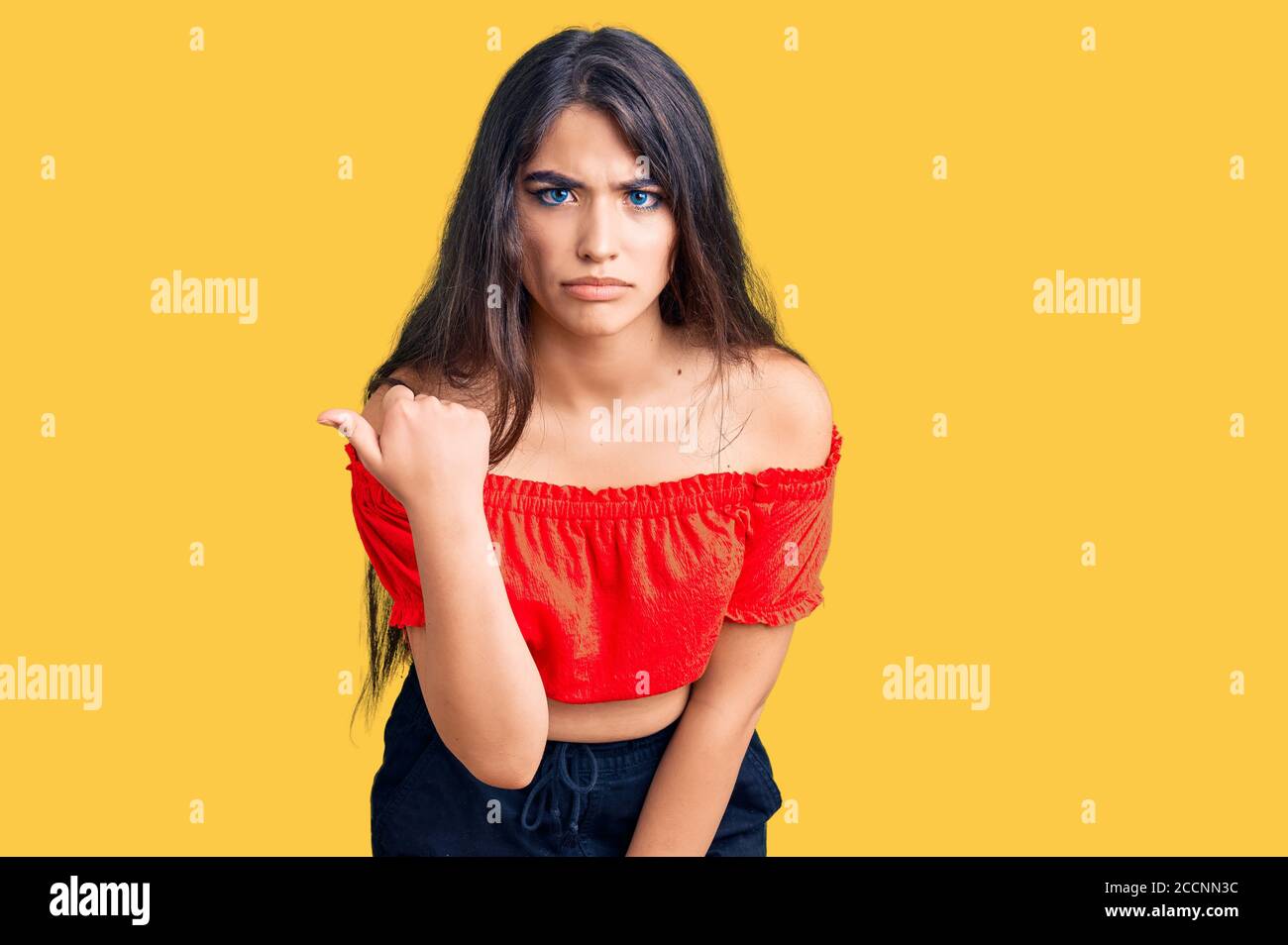 Brunette teenager girl wearing casual clothes angry and mad raising ...