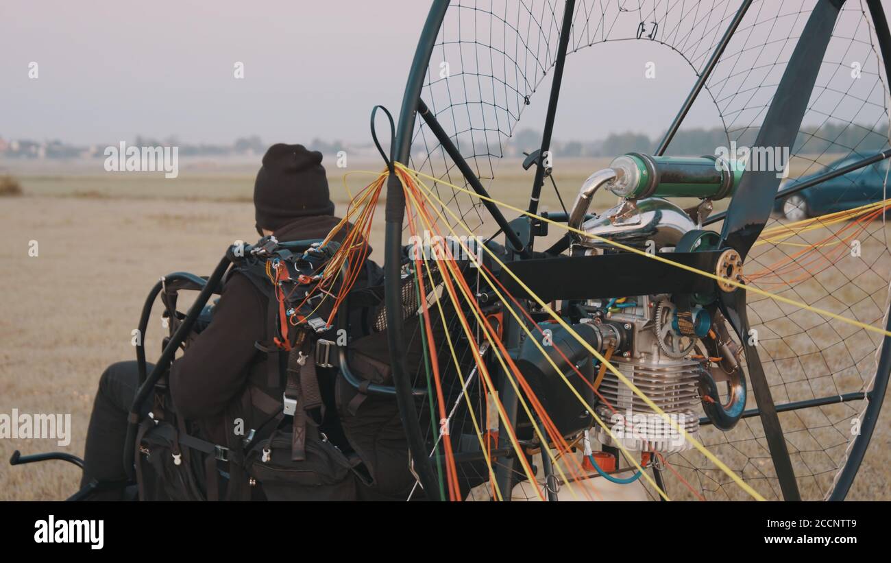 Paraglider sitting in the paramotor. Tandem paragliding, extreme sport ...