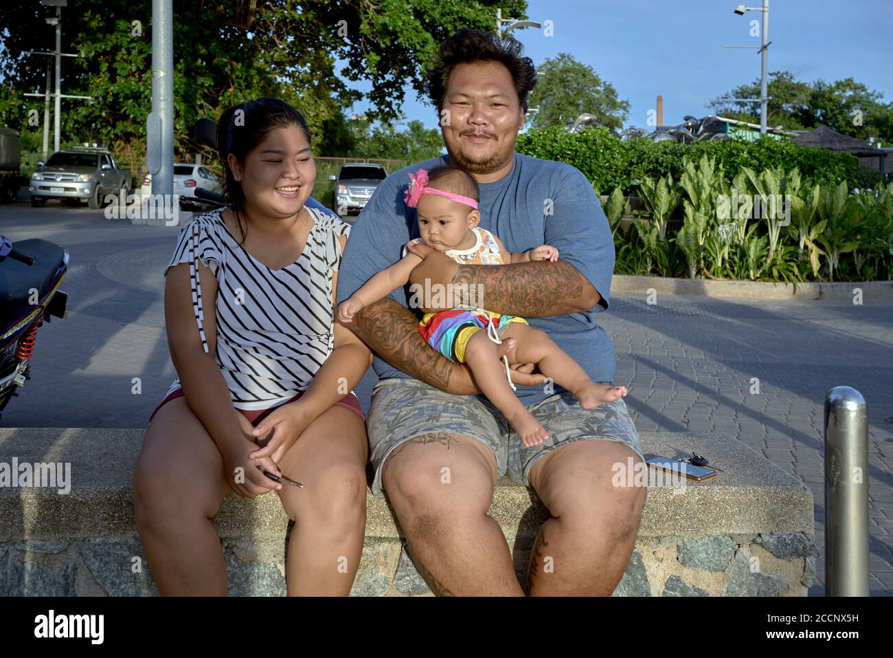 Thailand family of mother, father and infant child outdoor enjoying the ...