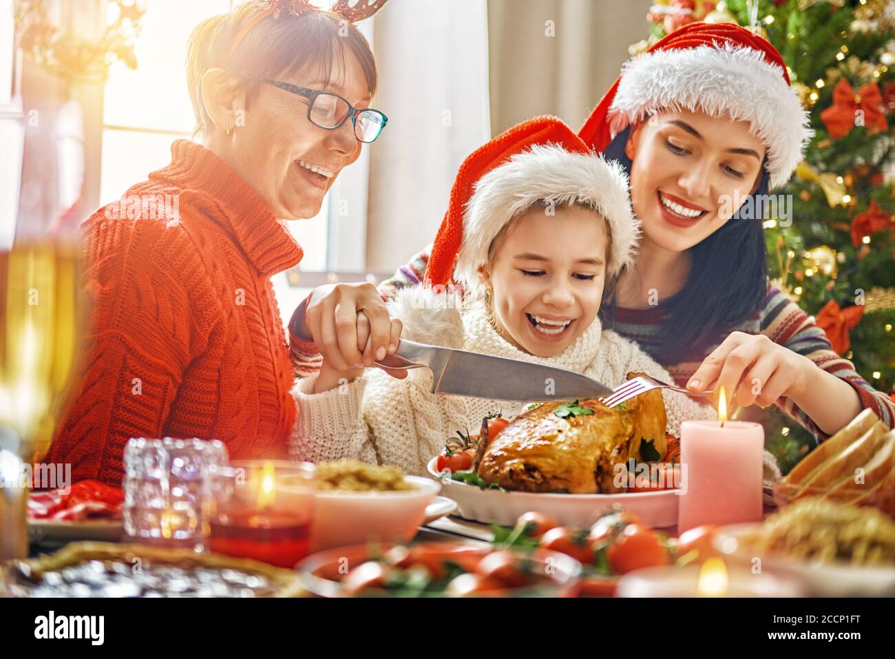 Merry Christmas! Happy family are having dinner at home. Celebration holiday and togetherness ...