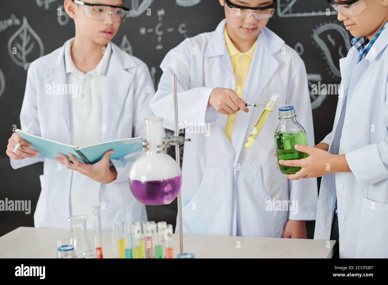 School students carrying out experiment Stock Photo - Alamy