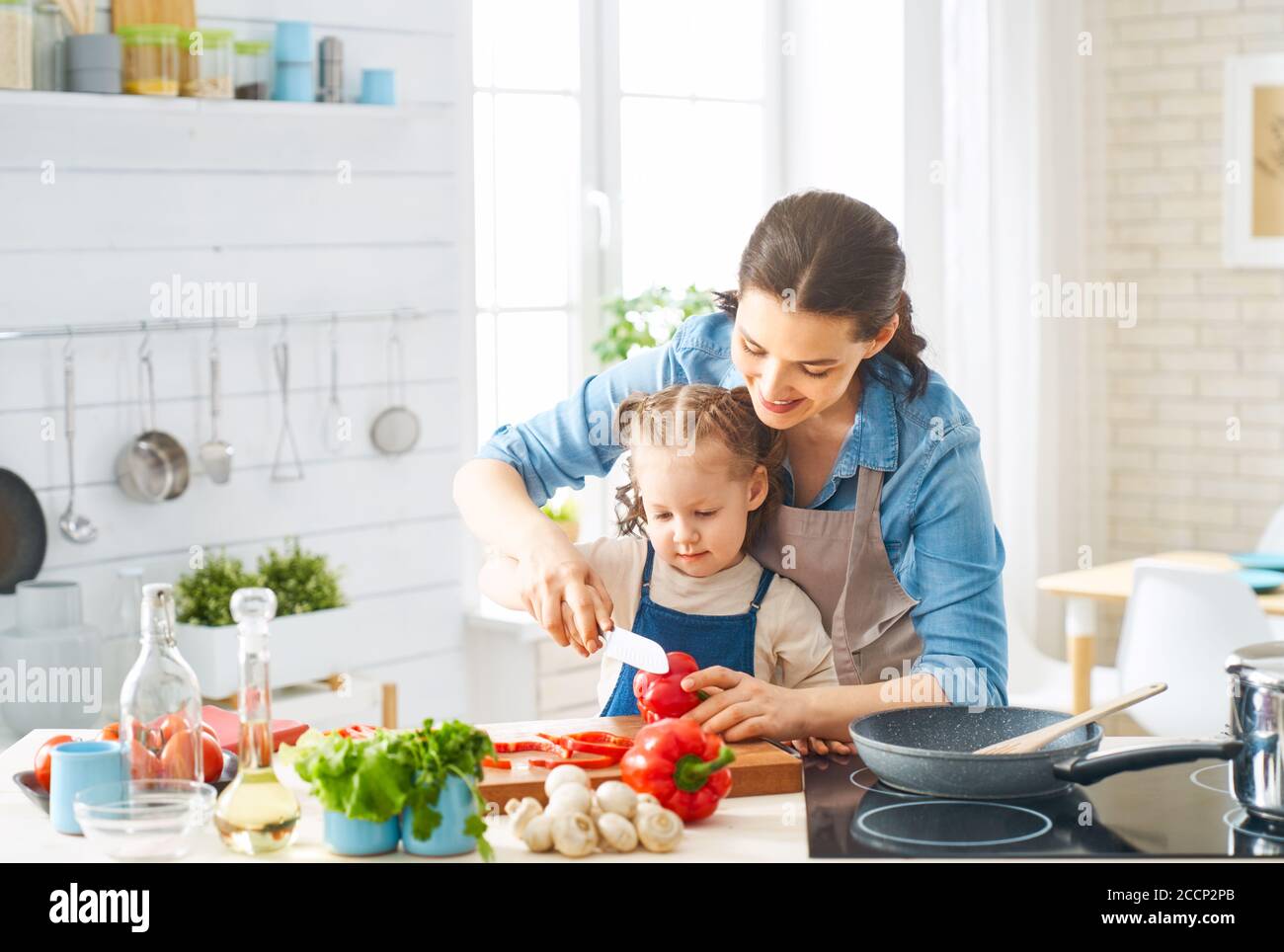 Healthy food at home. Happy family in the kitchen. Mother and child ...