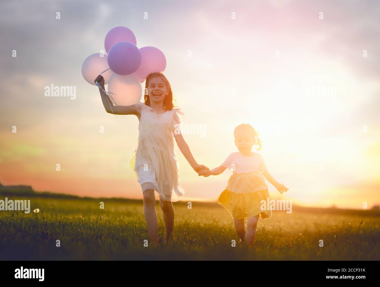 Happy kids are having fun on nature in the summer. Children are ...