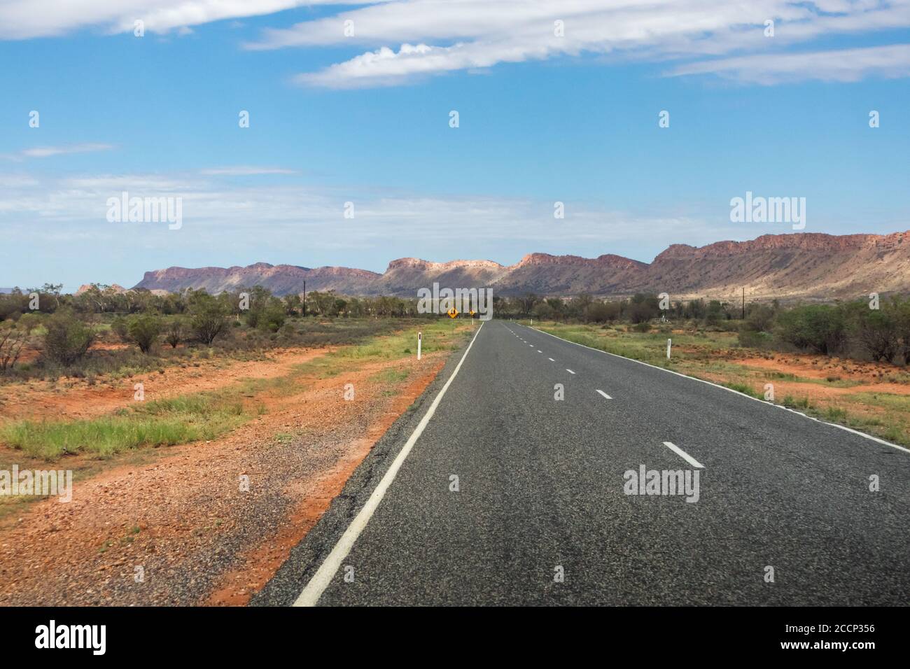 Driving towards the MacDonnell ranges. Empty road, no cars. Typical ...