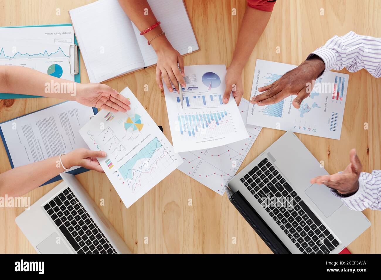 Managers analyzing reports Stock Photo - Alamy