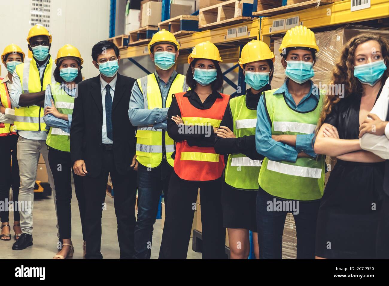 Group of factory industry workers working with face mask to prevent ...