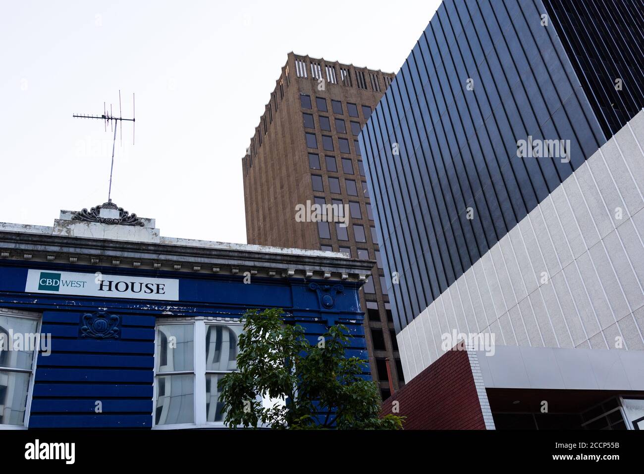 Traditional and modern buildings at the city. Blue house in front of ...
