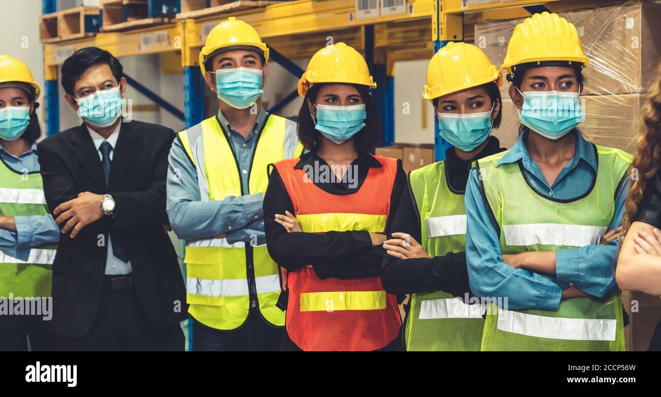 Group of factory industry workers working with face mask to prevent ...