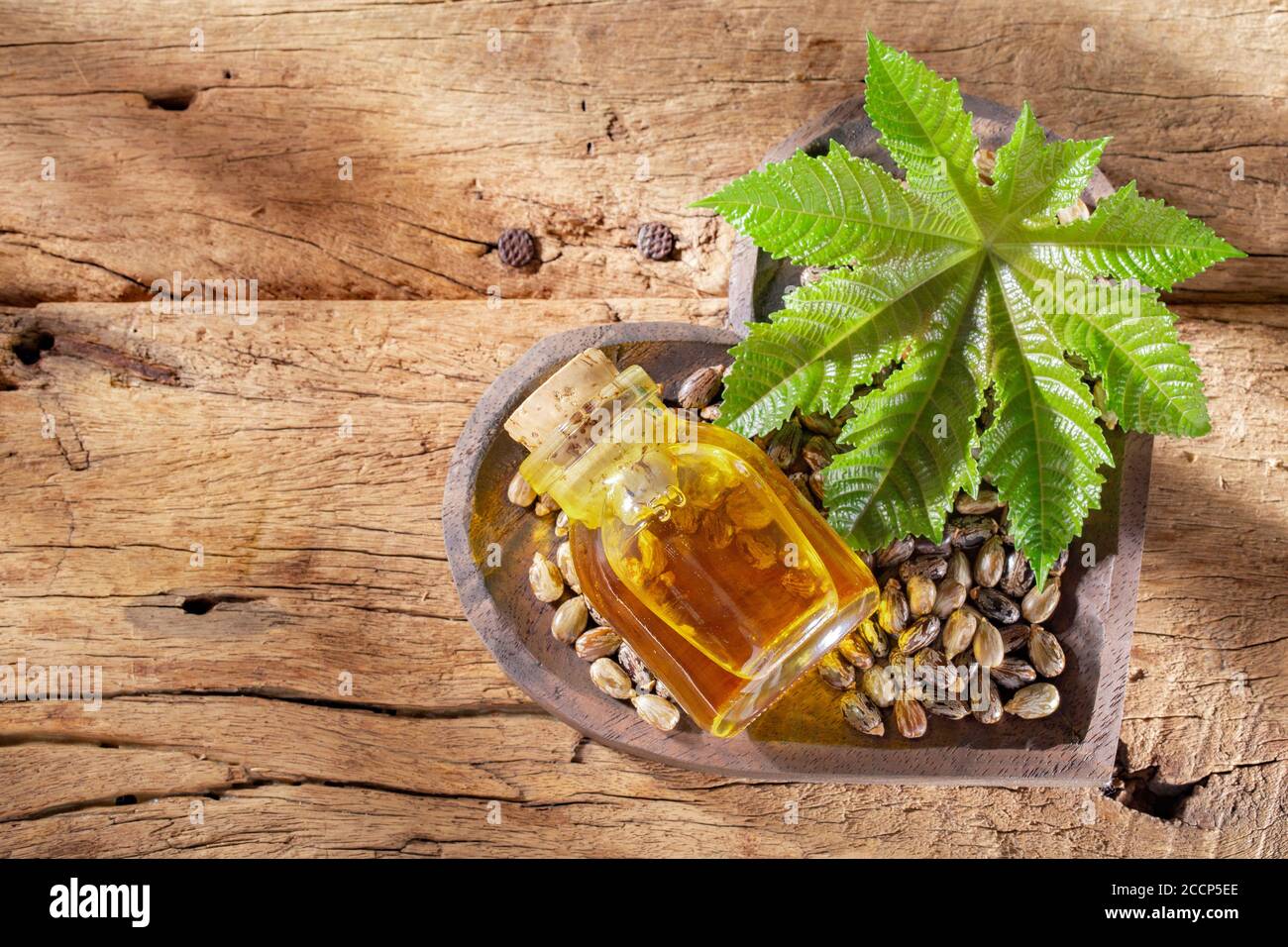 castor oil and seeds, on wooden background Stock Photo - Alamy