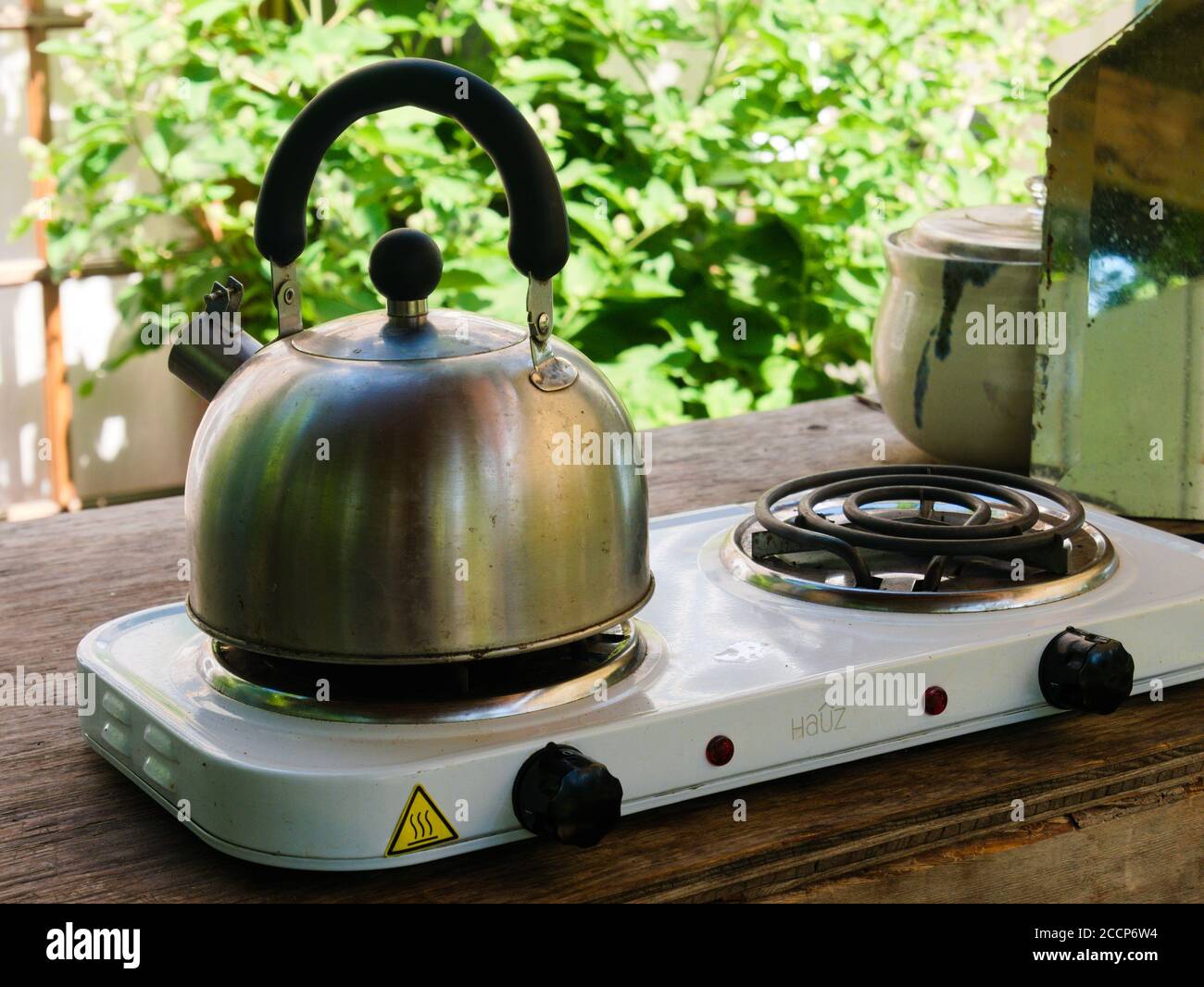 Kettle on a stove in an outdoor kitchen Stock Photo - Alamy