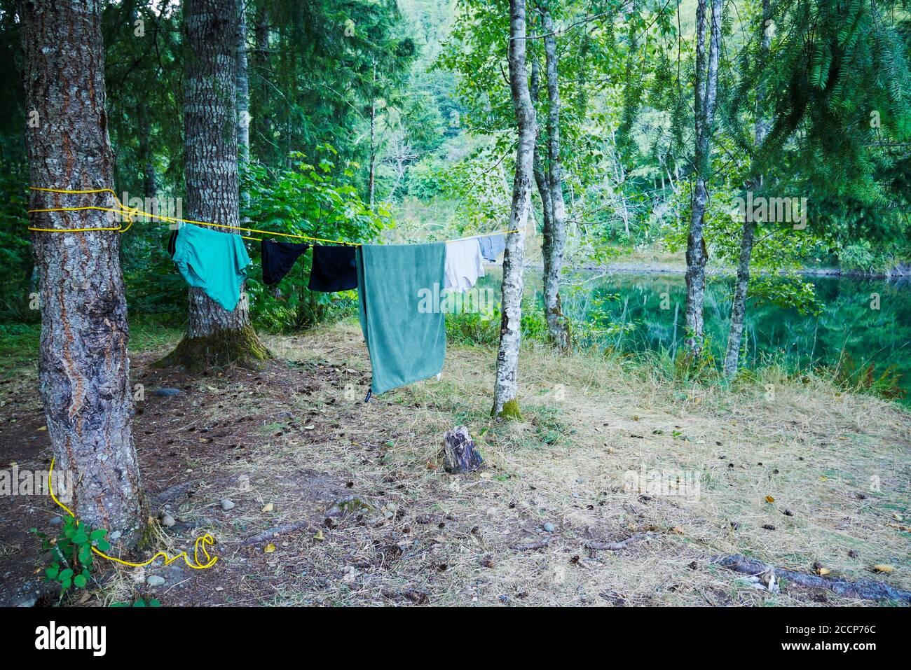 Clothes drying on a line in a campsite by a river Stock Photo - Alamy