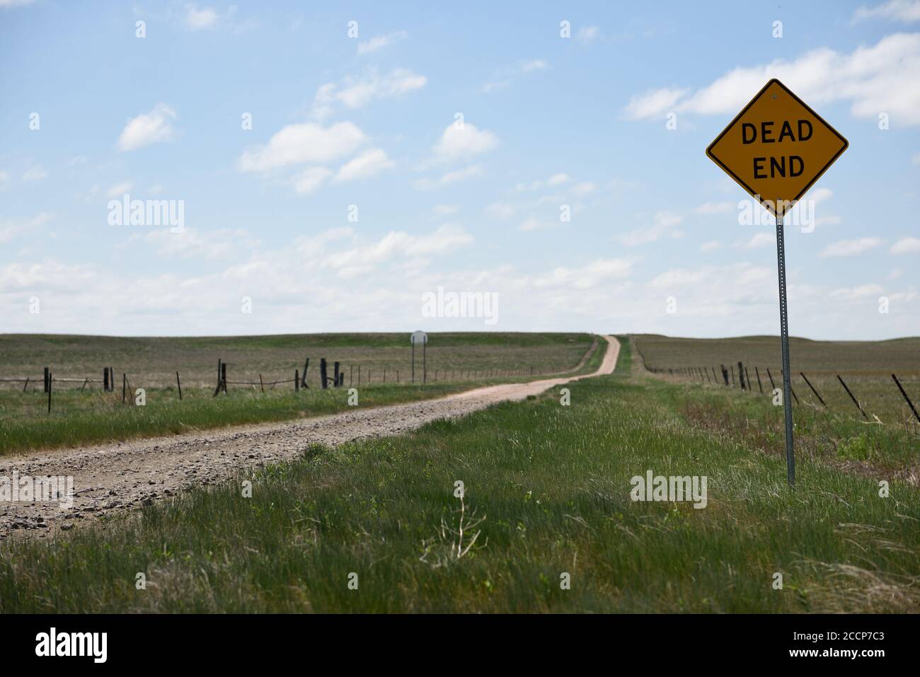 Yellow Dead End warning sign and rural country road leading to the ...