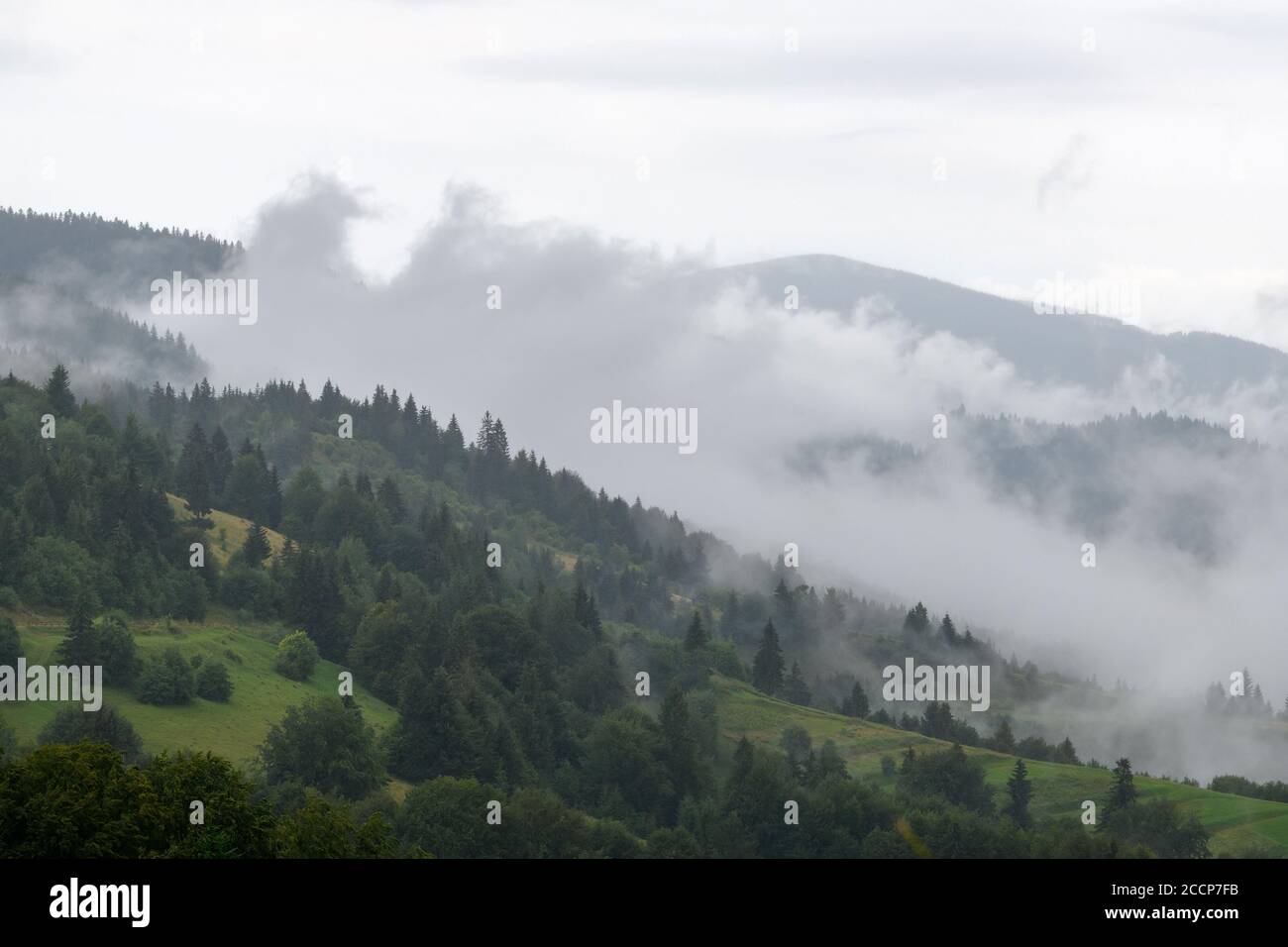 Majestic view on beautiful fog and cloud mountains in mist landscape. Summer time after rain ...