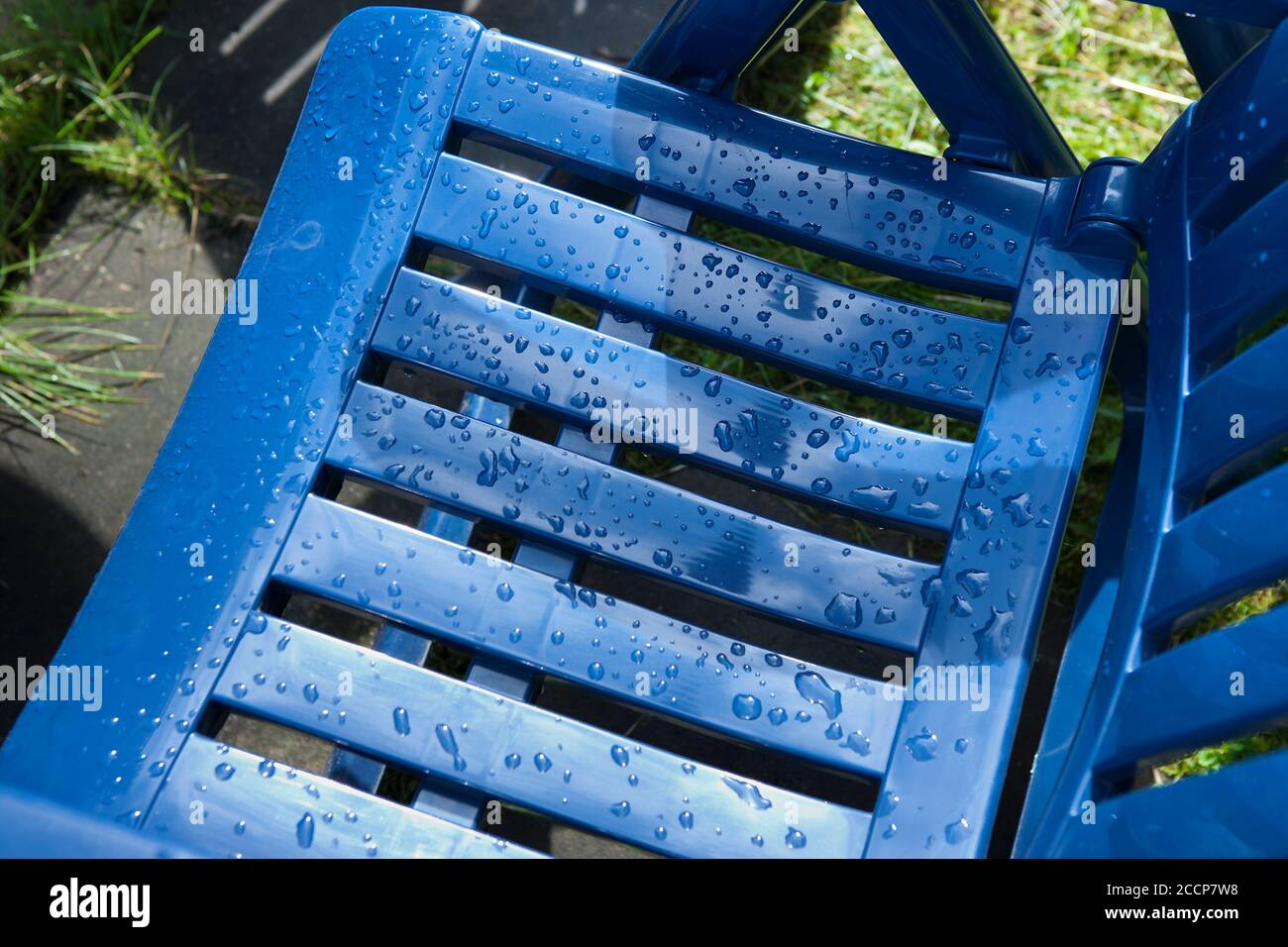 Wet seat of a folding garden chair, outdoor closeup Stock Photo - Alamy
