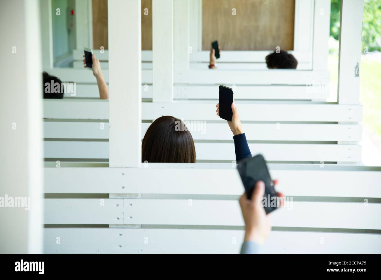 Men and Woman Raising Their Smartphone Stock Photo - Alamy