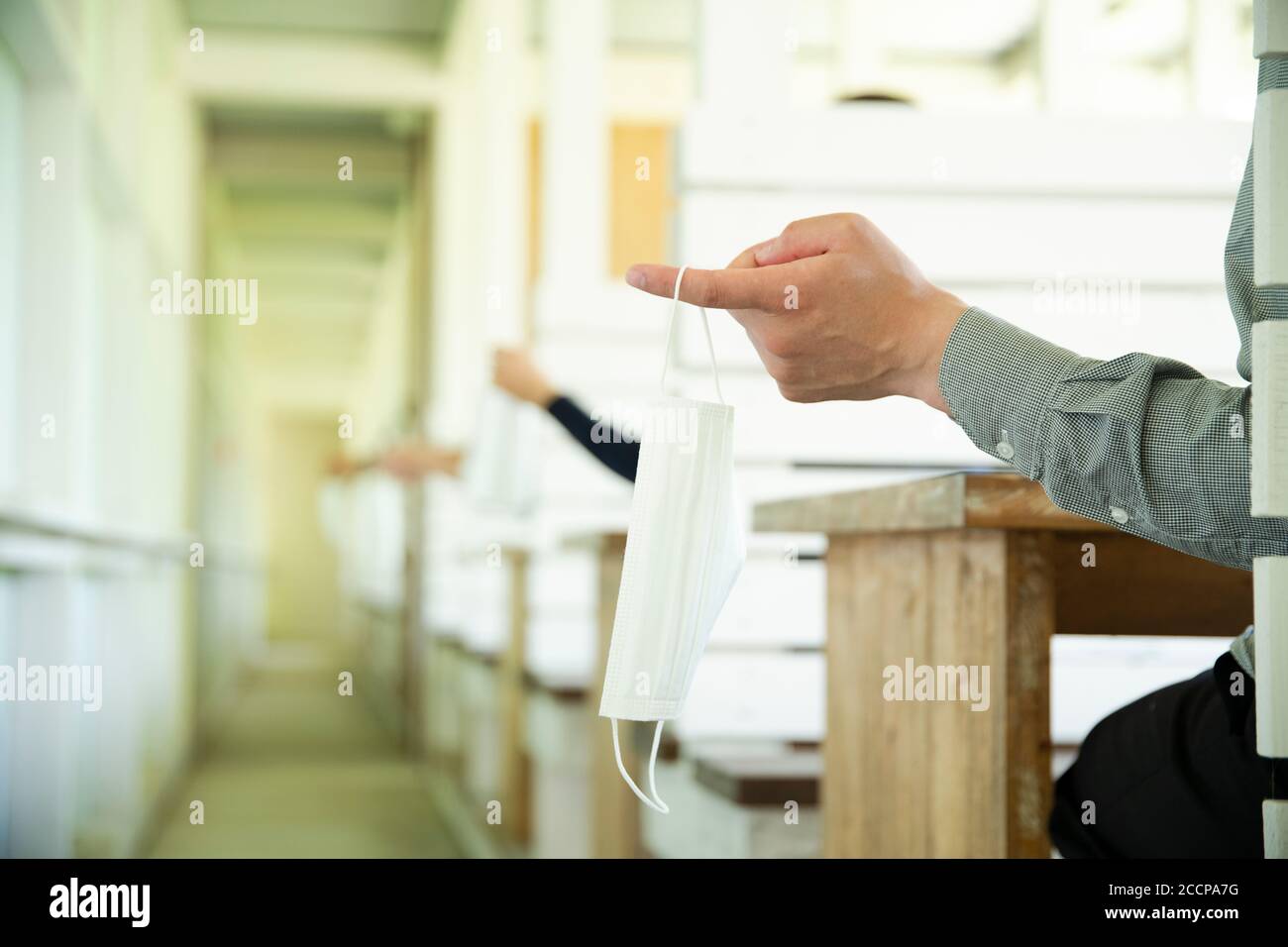 Man and Woman Hanging Face Masks on Their Finger Stock Photo - Alamy