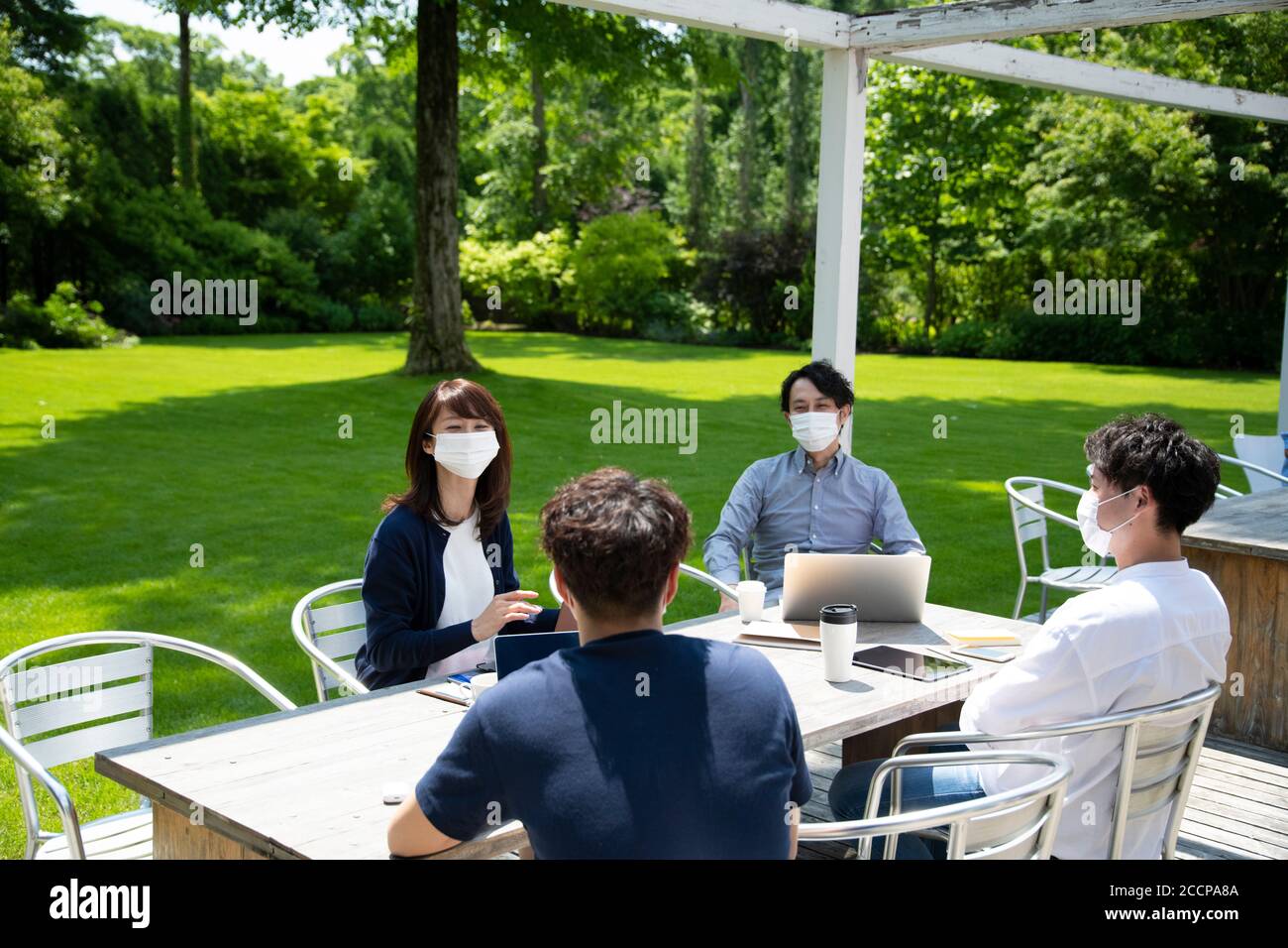 Men and Woman Having a Meeting with Face Mask on an Outdoor Office that ...