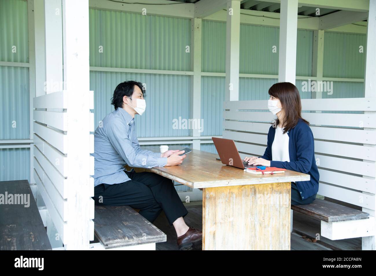 Mature Man and Woman Having a Meeting with Face Mask on an Outdoor ...