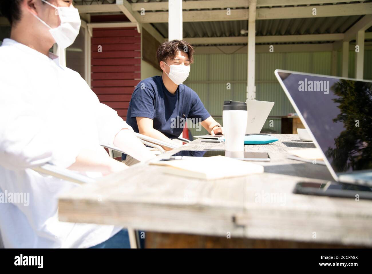 Young Men Having a Meeting with Face Mask on an Outdoor Office that Set ...