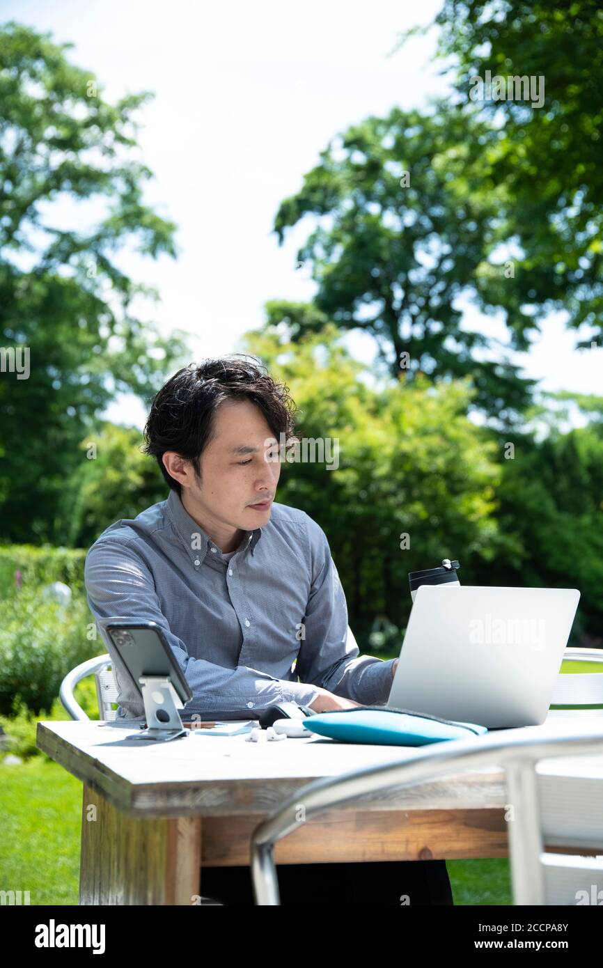 Mature Man are Working on an Outdoor Office that Set Social Distancing ...