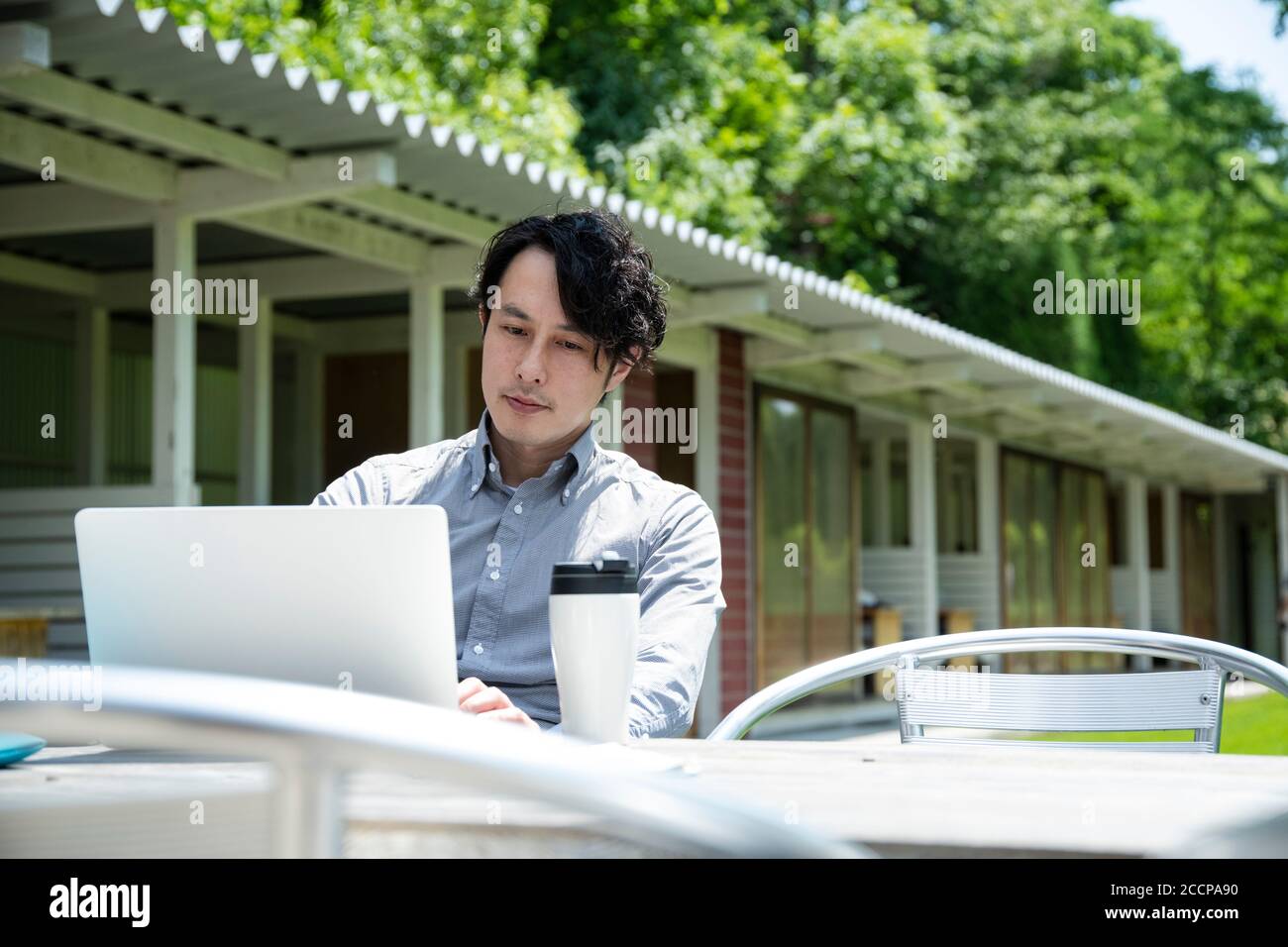 Mature Man are Working on an Outdoor Office that Set Social Distancing ...