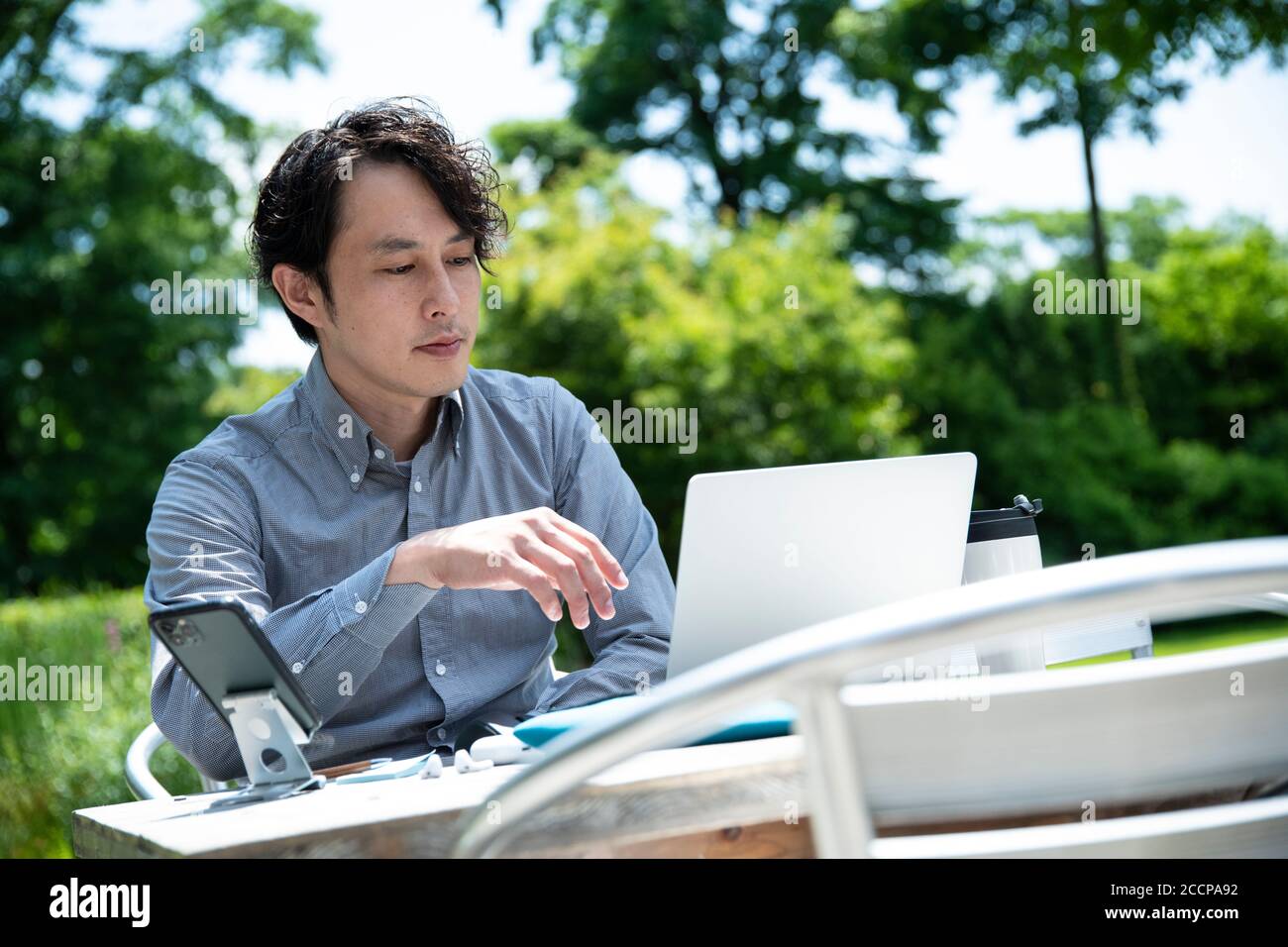 Mature Man are Working on an Outdoor Office that Set Social Distancing ...