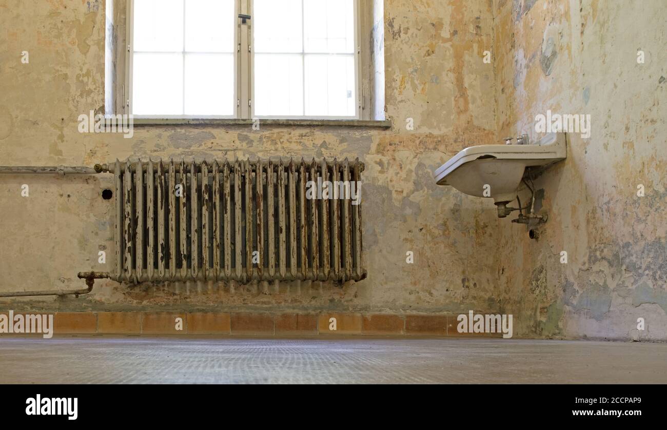 Old radiator and sink in an empty historic home, bathroom Stock Photo ...