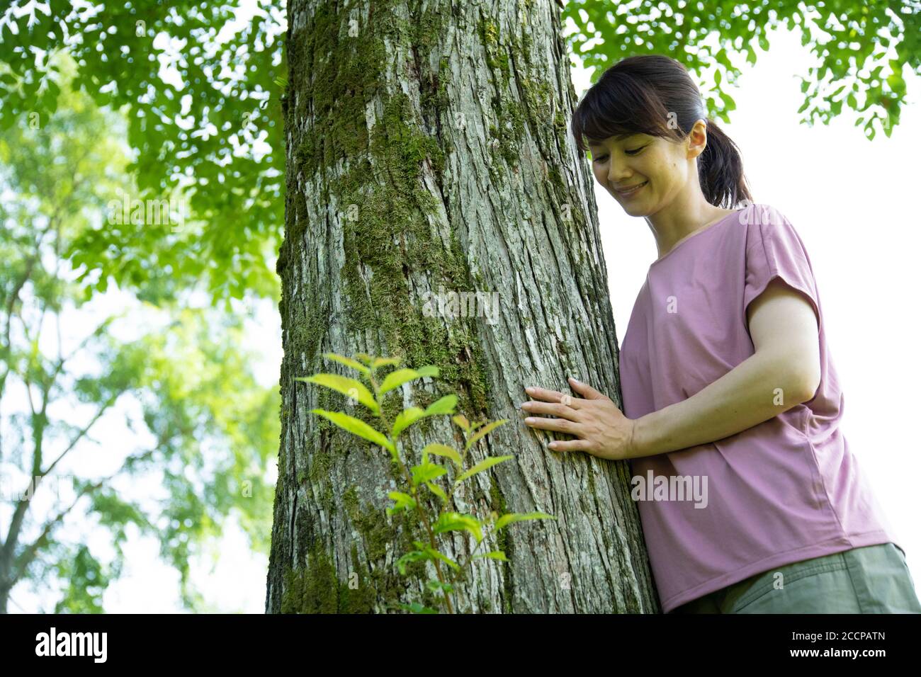 Mature Woman Close to the Tree Stock Photo - Alamy