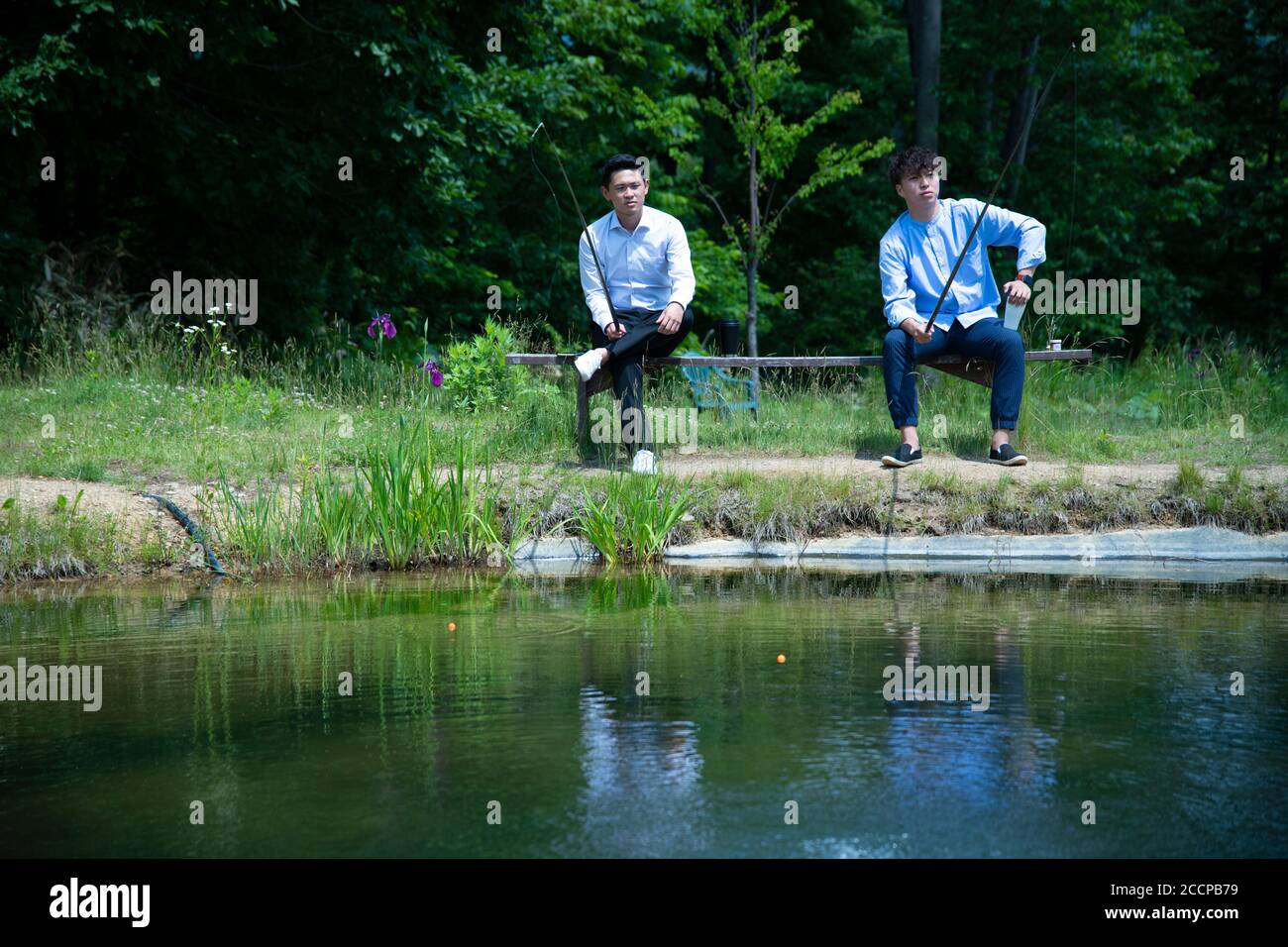 Young men fishing hi-res stock photography and images - Alamy