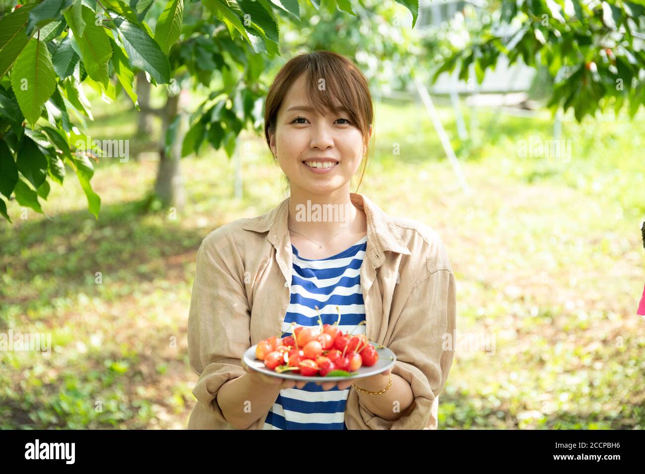 Young Woman Having Cherry Stock Photo - Alamy