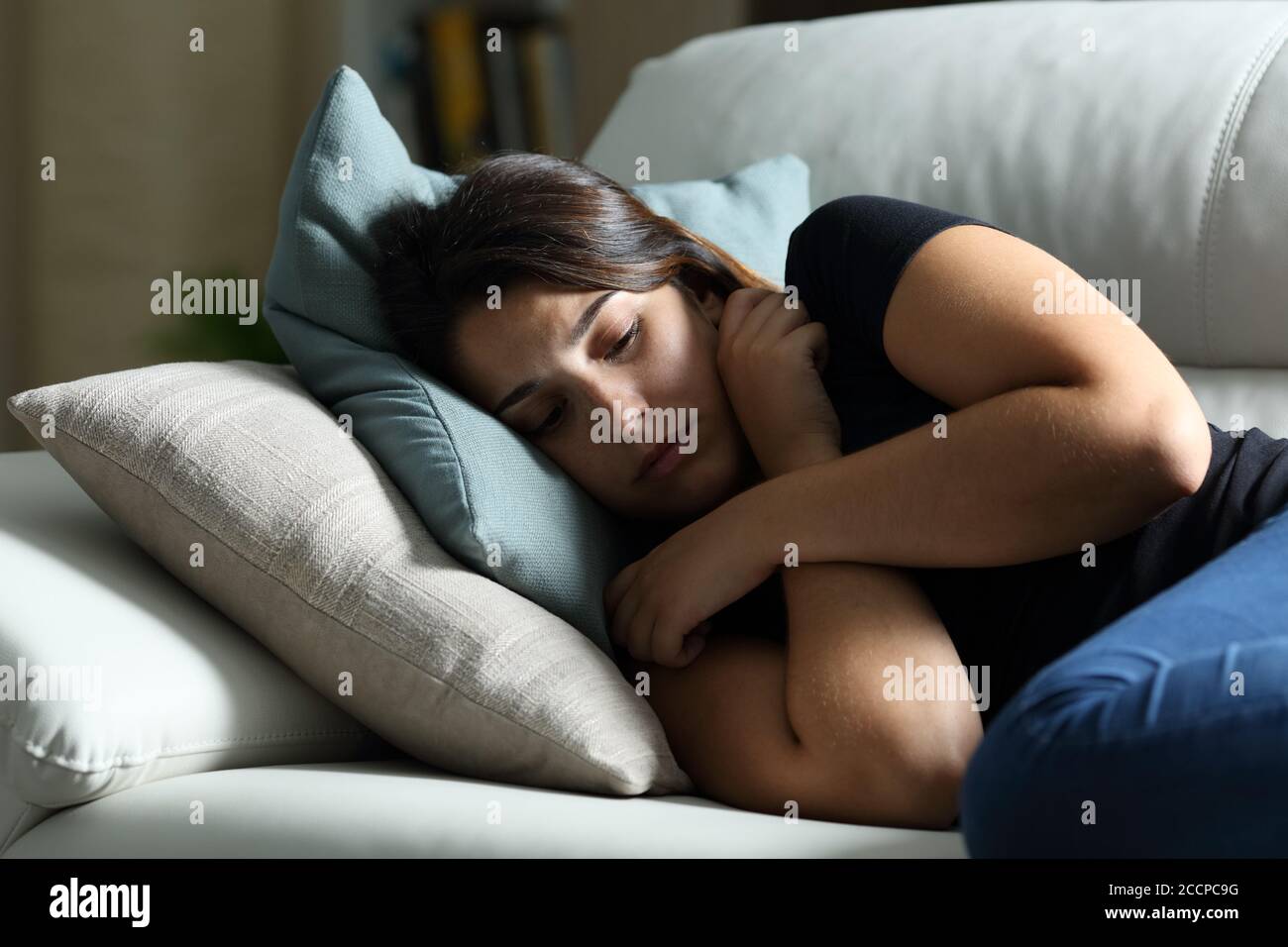 Woman sad alone sofa hi-res stock photography and images - Alamy