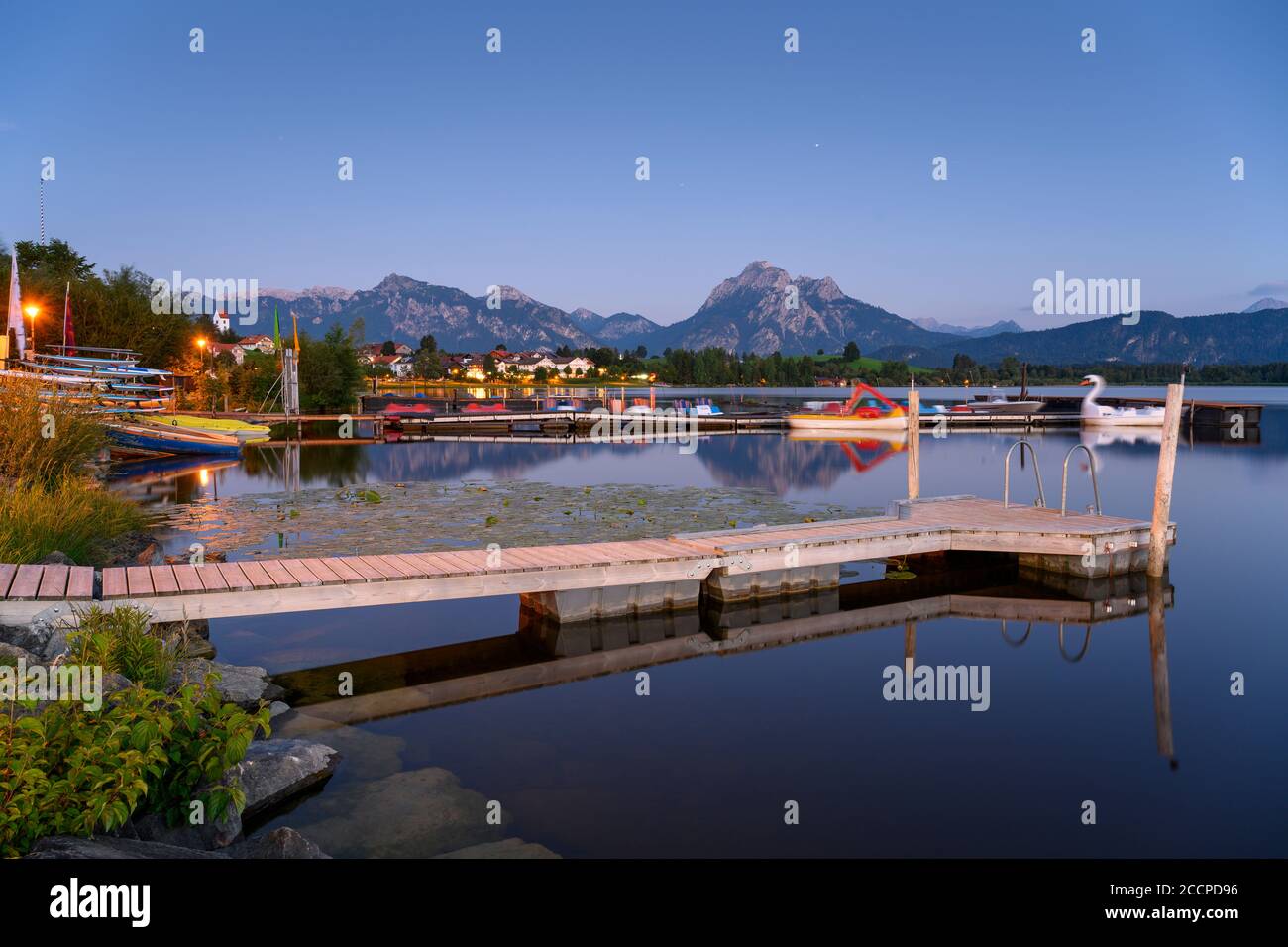 Wooden landing stage at Hopfensee, in the background the Alps and the ...