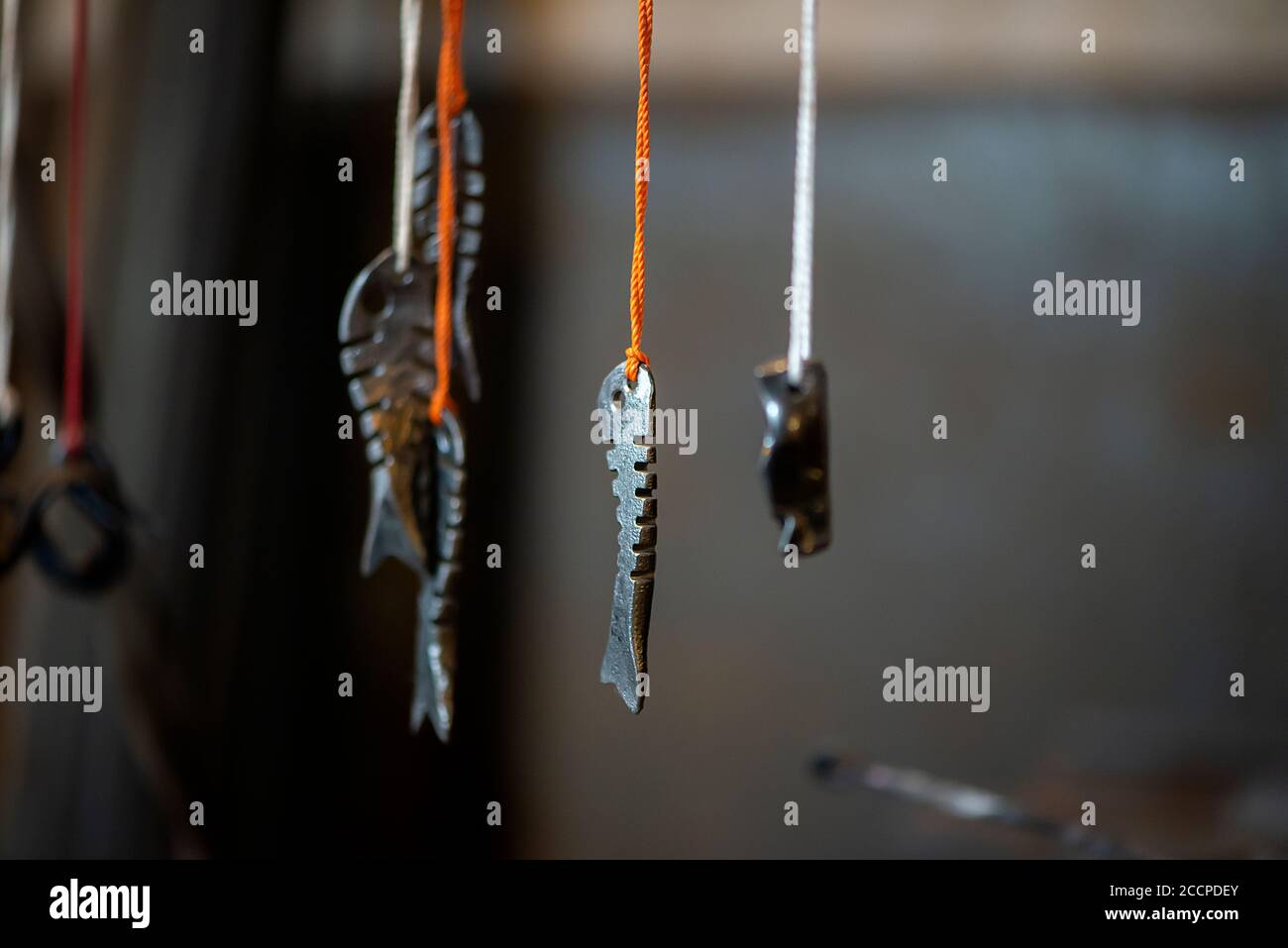 Blacksmith decorative elements hanging at forge, workshop. Handmade ...
