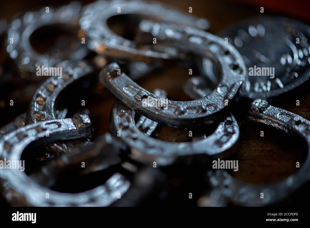 Blacksmith decorative elements horseshoes at forge, workshop. Handmade ...