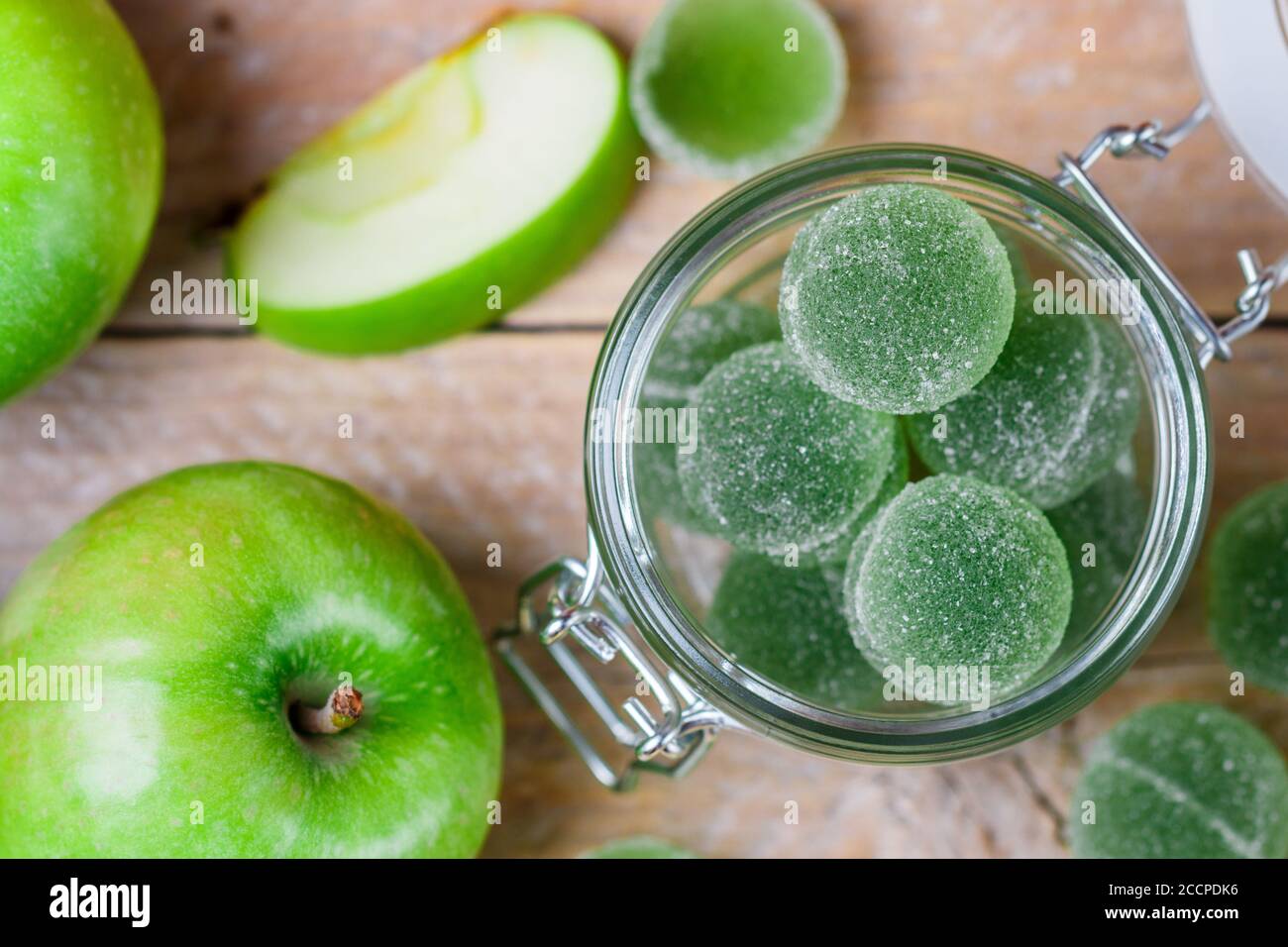 Apple green marmalade candy in sugar in a glass jar. Delicious homemade ...