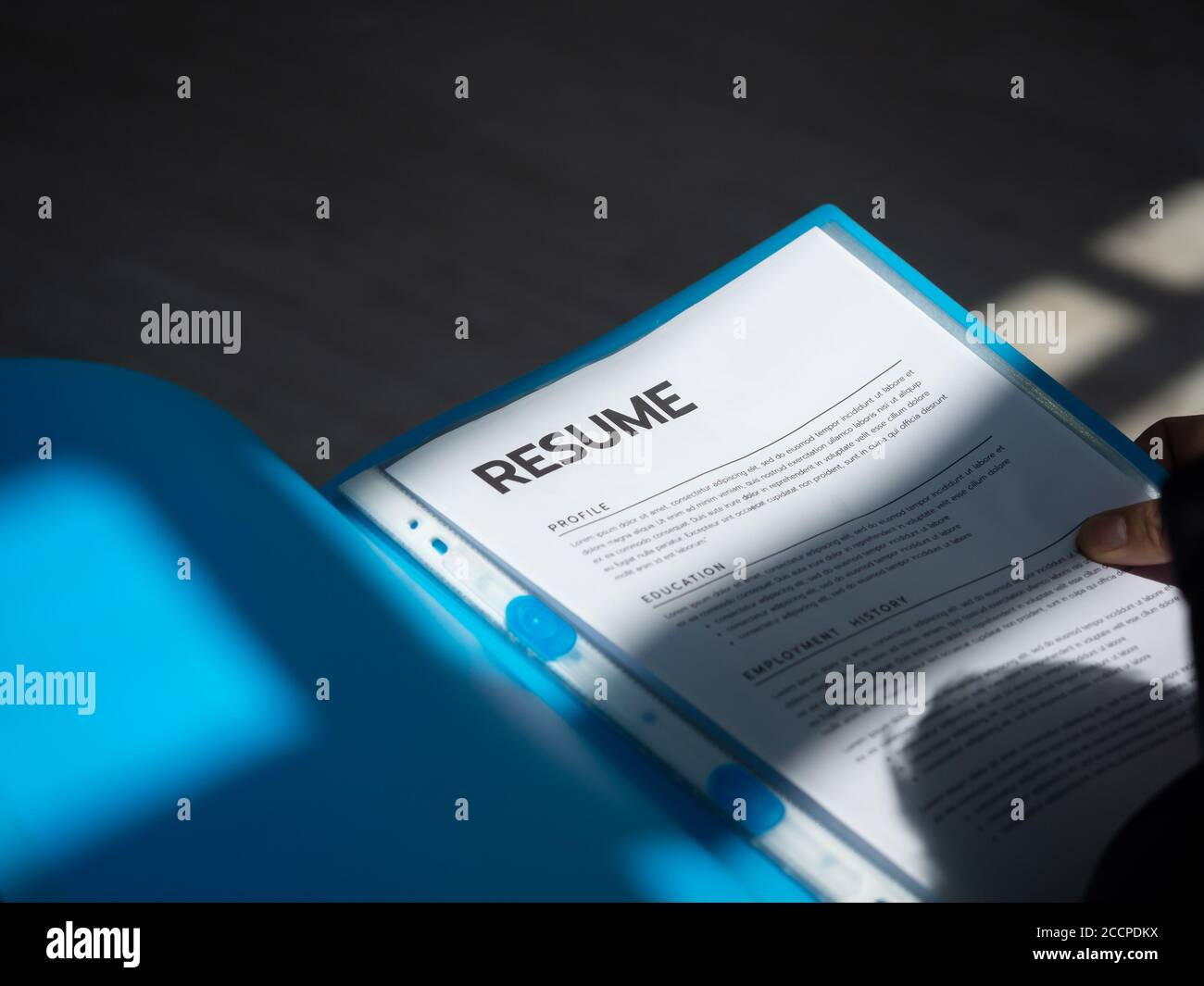 Close-up resume documents or curriculum vitae paper in hands of a ...