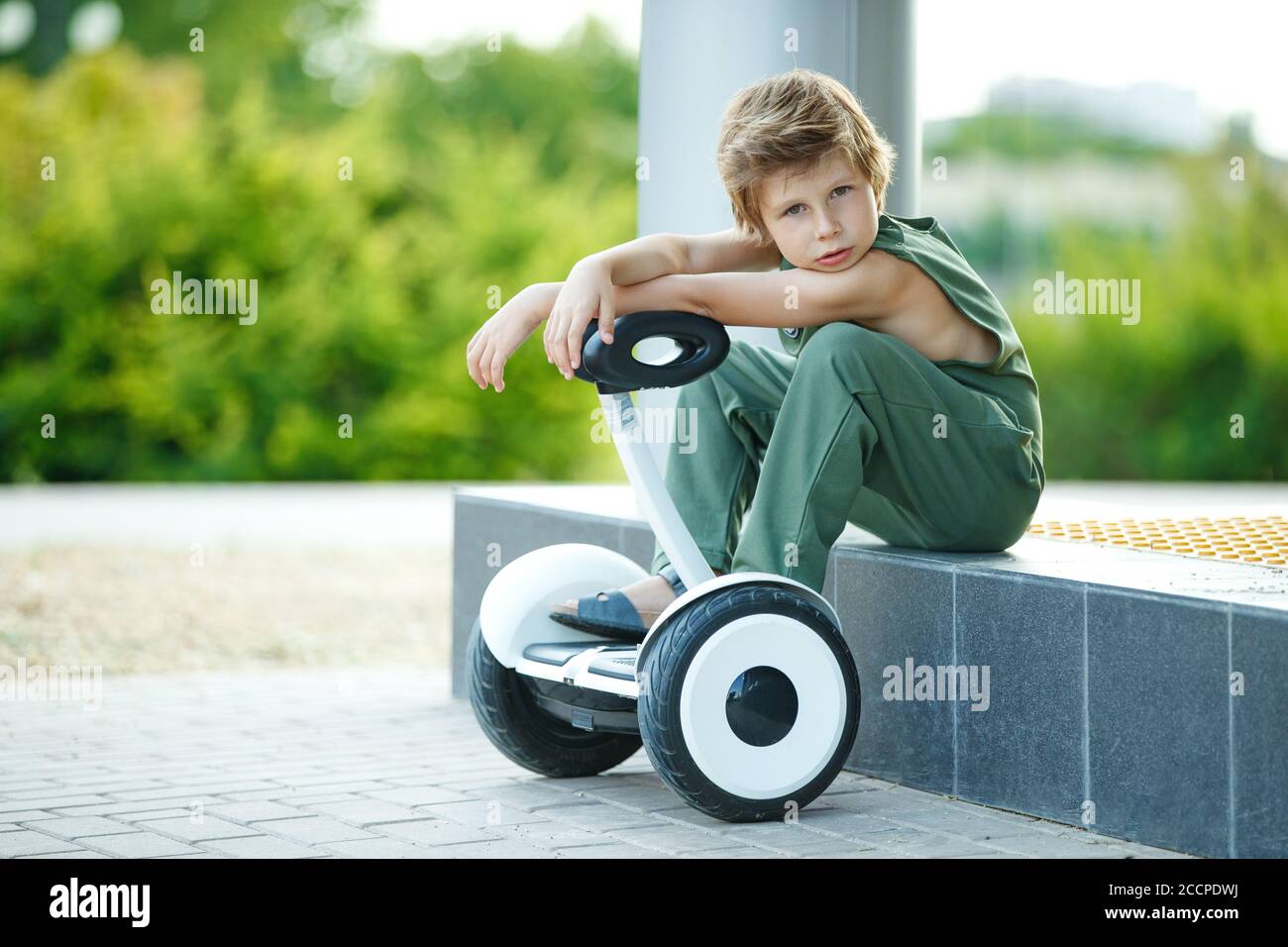 The child goes in for sports. A little boy is riding a hoverboard Stock ...
